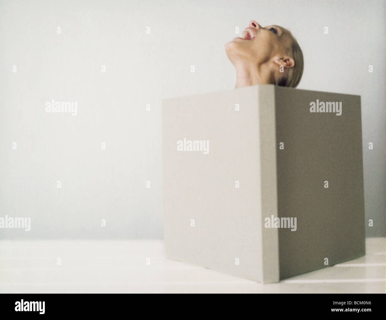 Woman sitting behind open book, shouting Stock Photo - Alamy