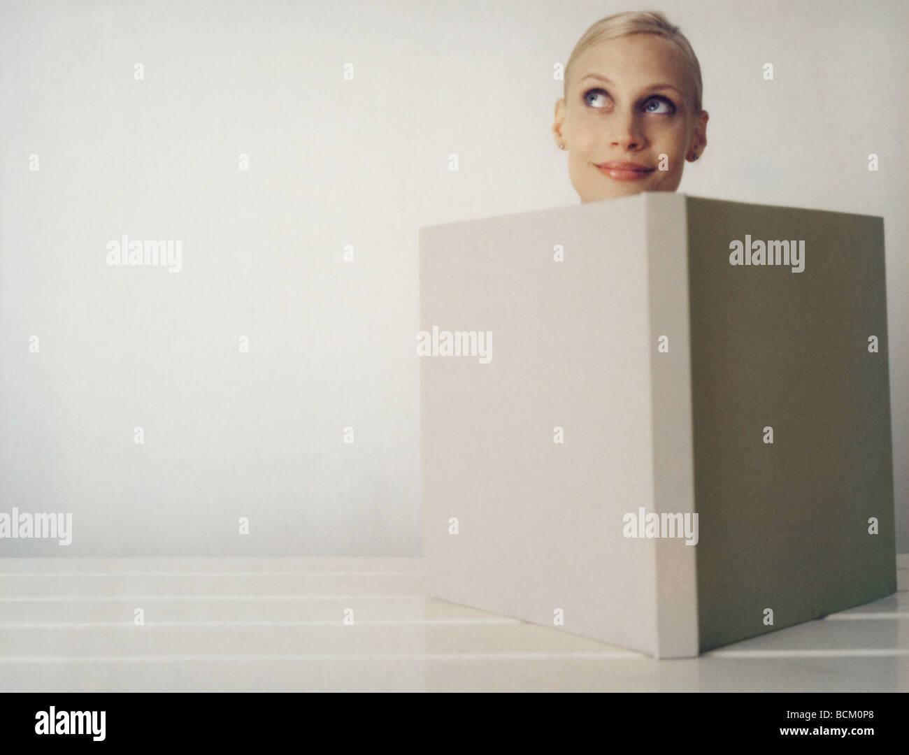 Woman behind open book, looking up, close-up Stock Photo - Alamy