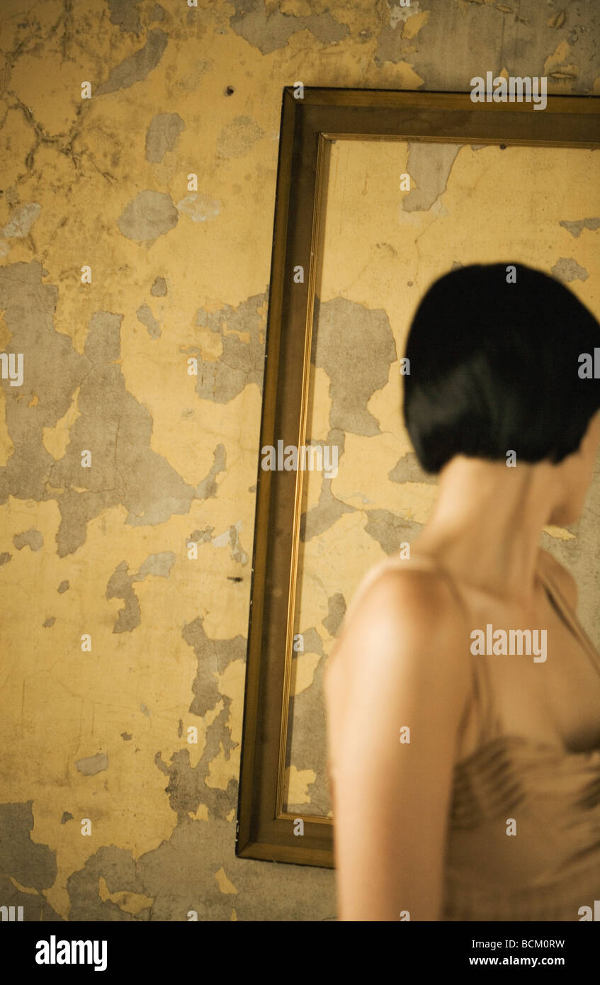 Woman turning frame peeling wall hi-res stock photography and images ...