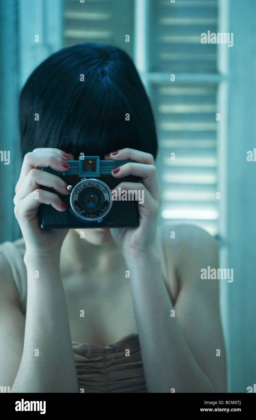 Woman taking photograph, front view Stock Photo - Alamy