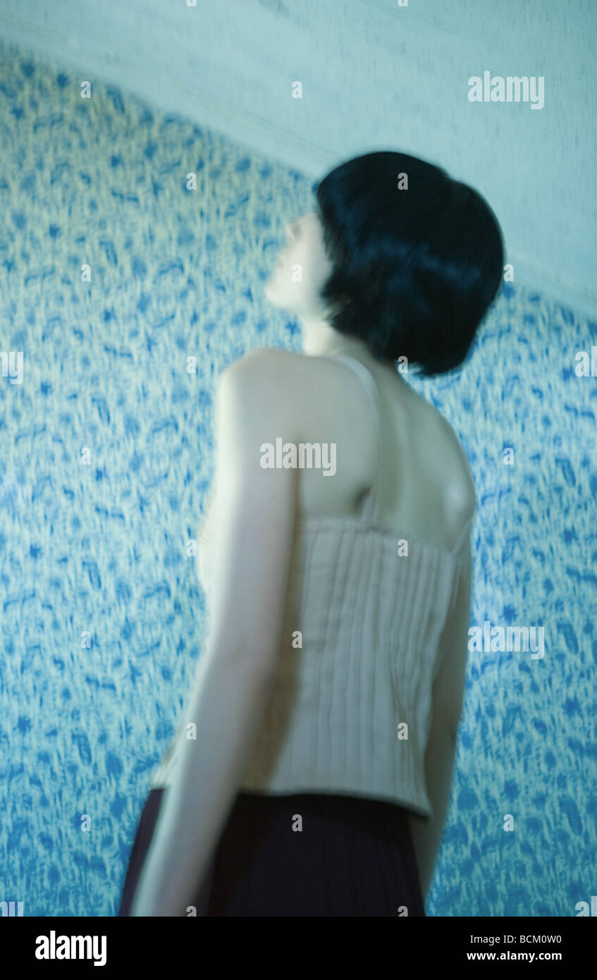 Woman standing, facing wall, low angle view Stock Photo - Alamy