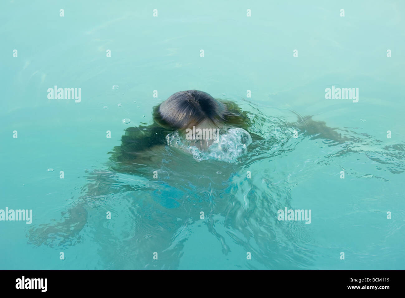Woman emerging from water Stock Photo - Alamy