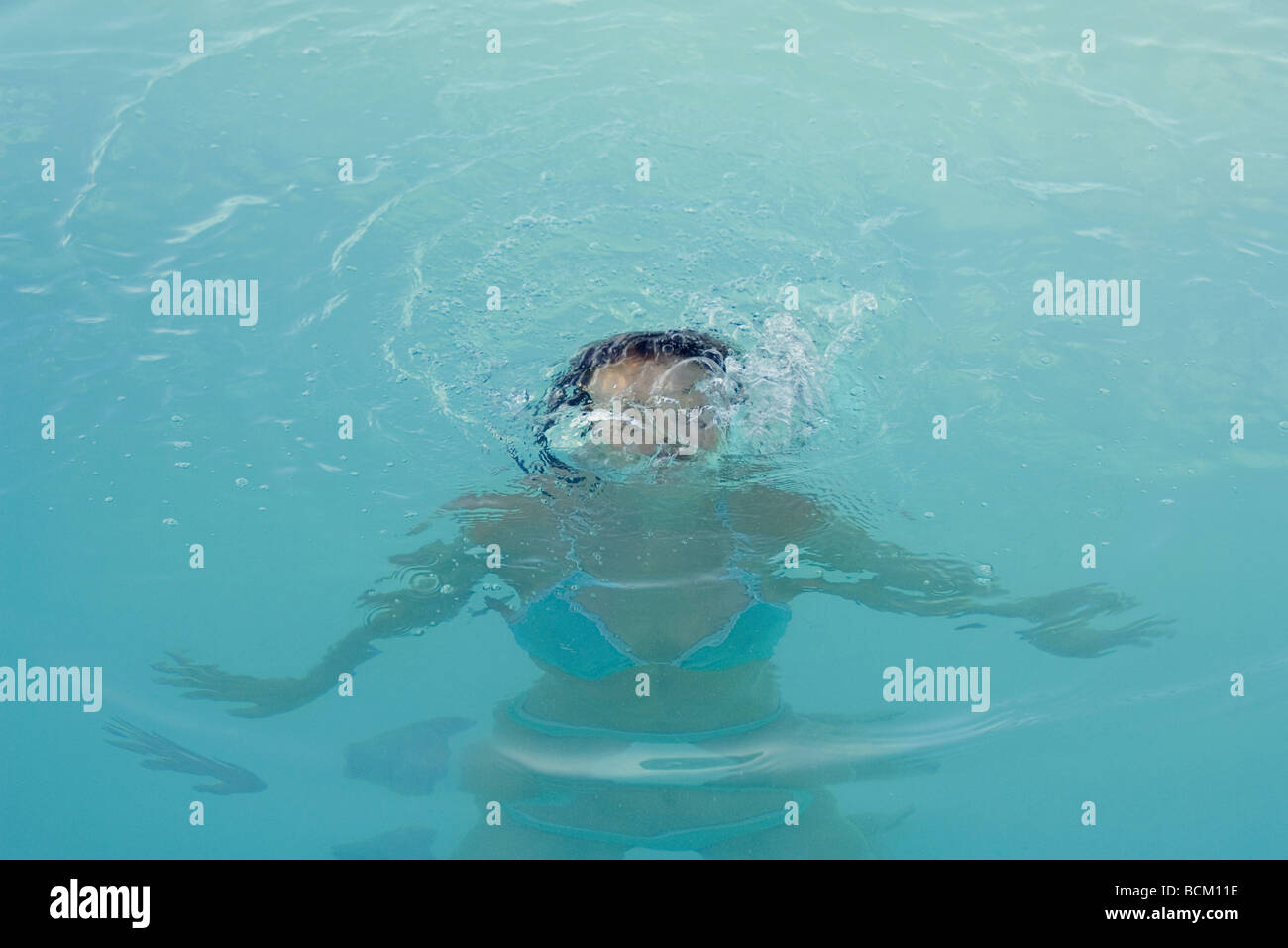 Woman emerging from water Stock Photo - Alamy