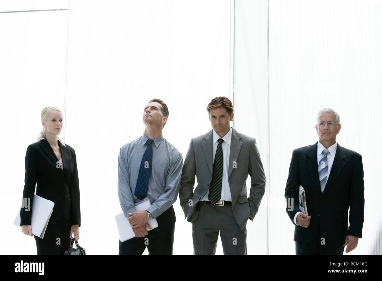 Business people standing in various poses, three quarter length, front ...