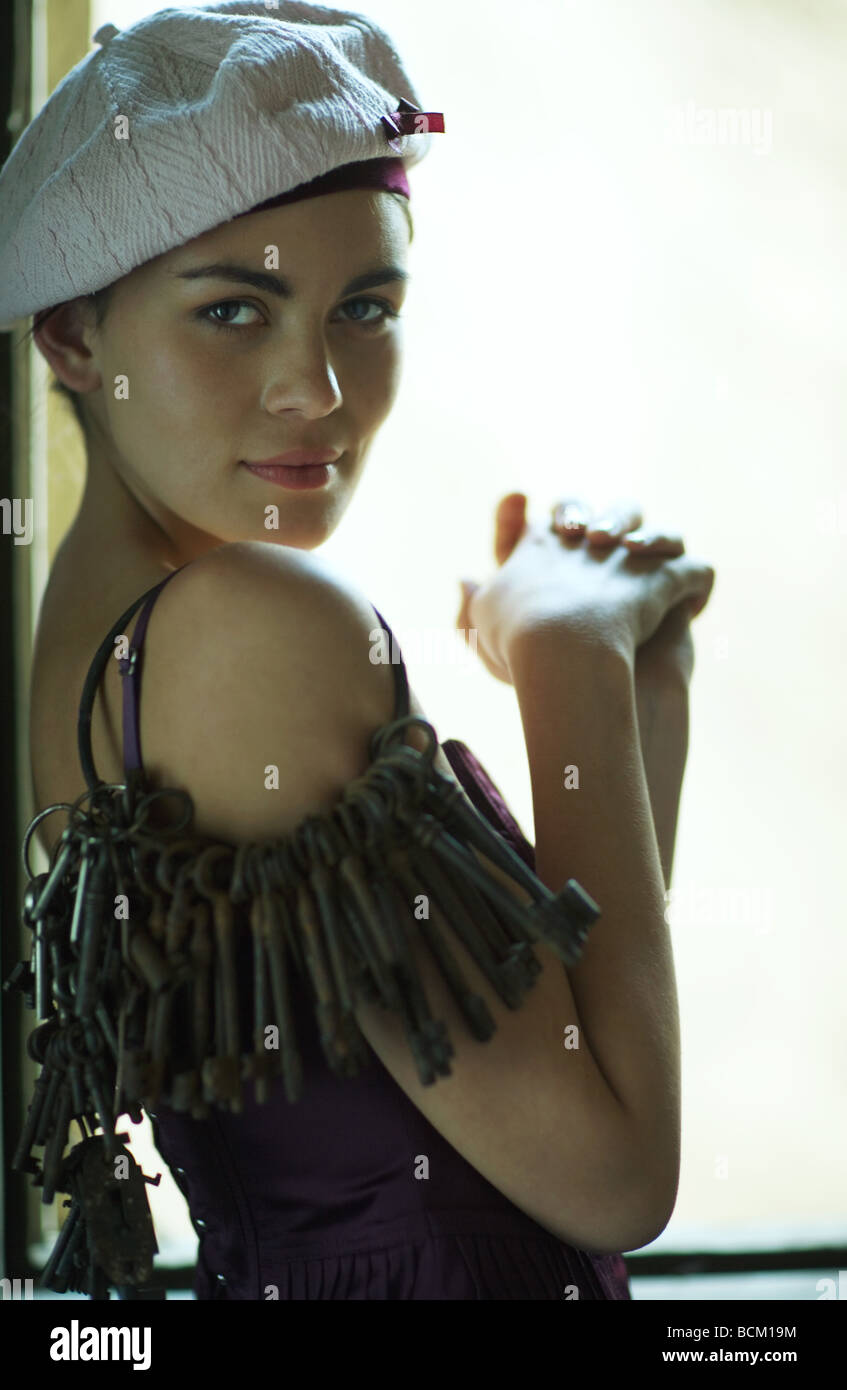Woman looking at camera, keys on shoulder, side view, close-up Stock ...