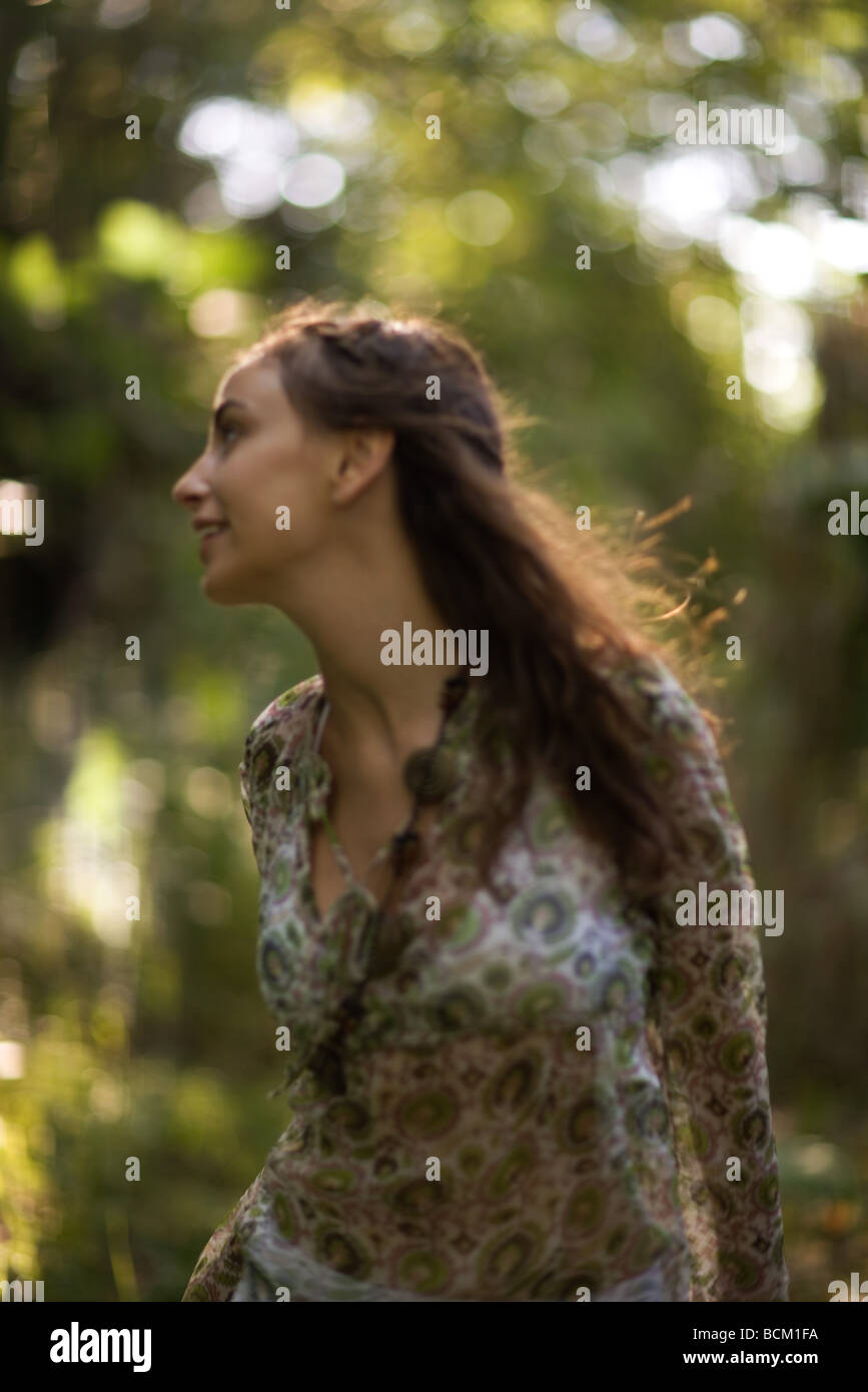 Young woman turning head, outdoors, selective focus Stock Photo - Alamy