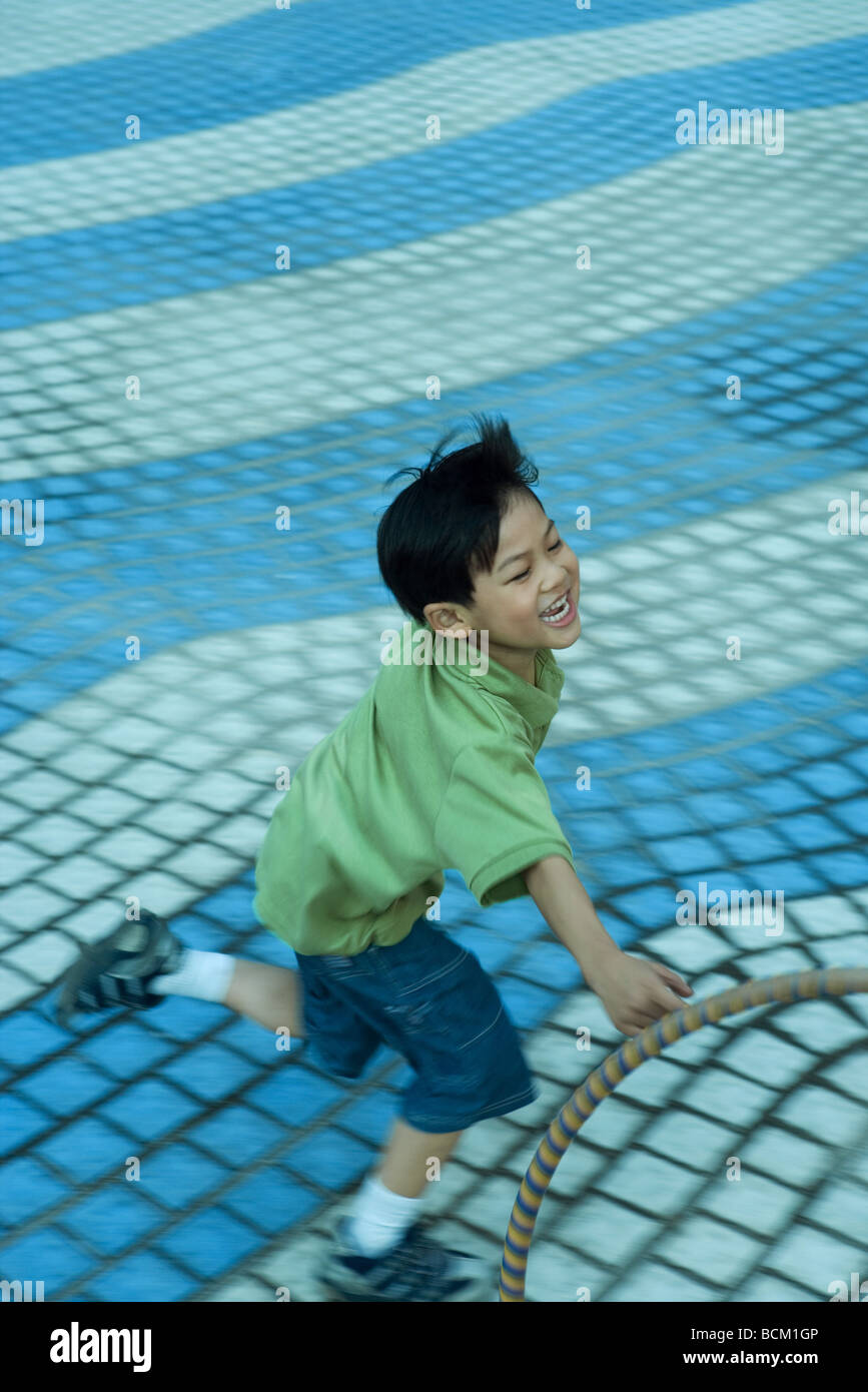 Little boy playing plastic hoop hi-res stock photography and images - Alamy