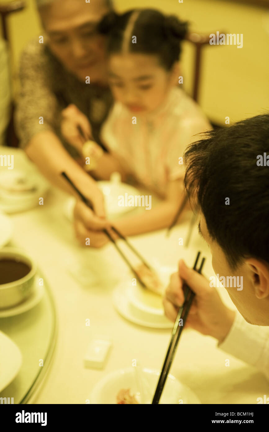 Little chinese girl eating chopsticks hi-res stock photography and ...