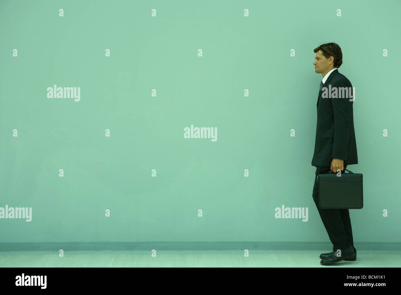 Side profile of a businessman walking Stock Photo - Alamy
