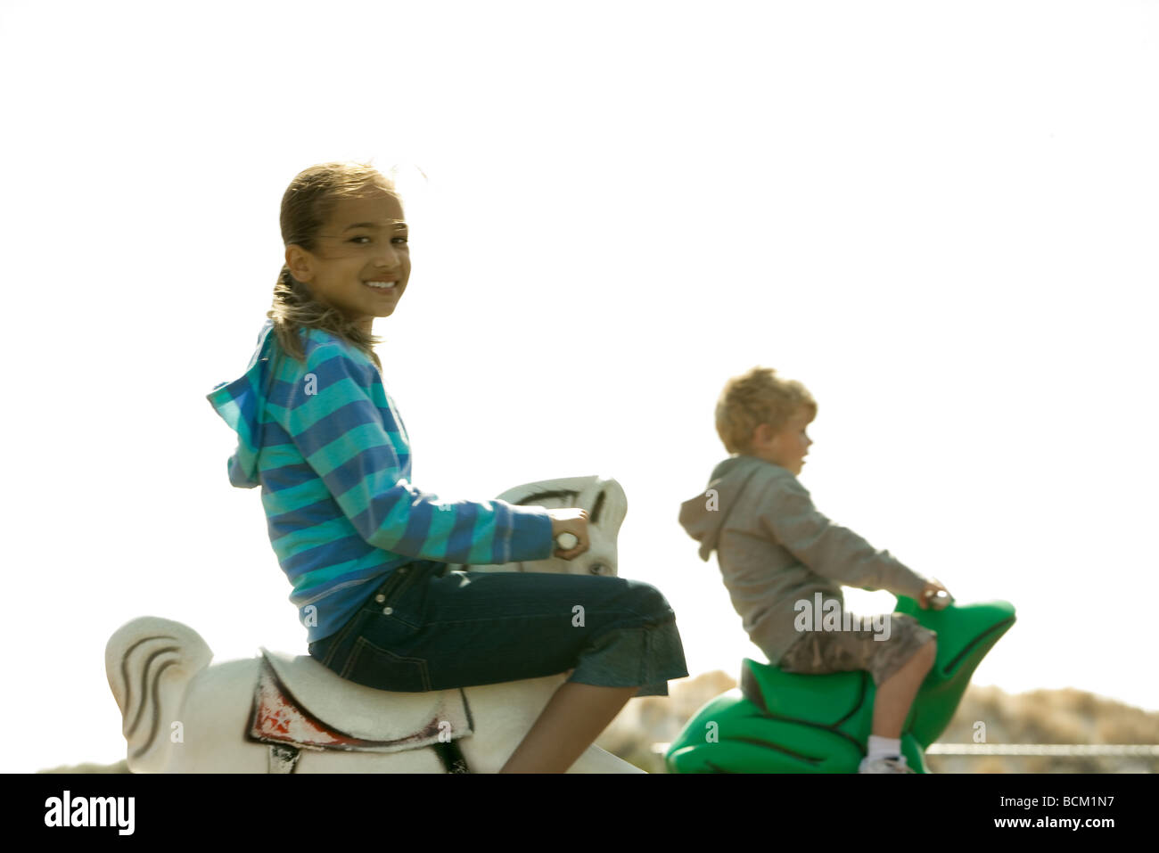 Children riding rocking horses on playground, focus on foreground Stock ...