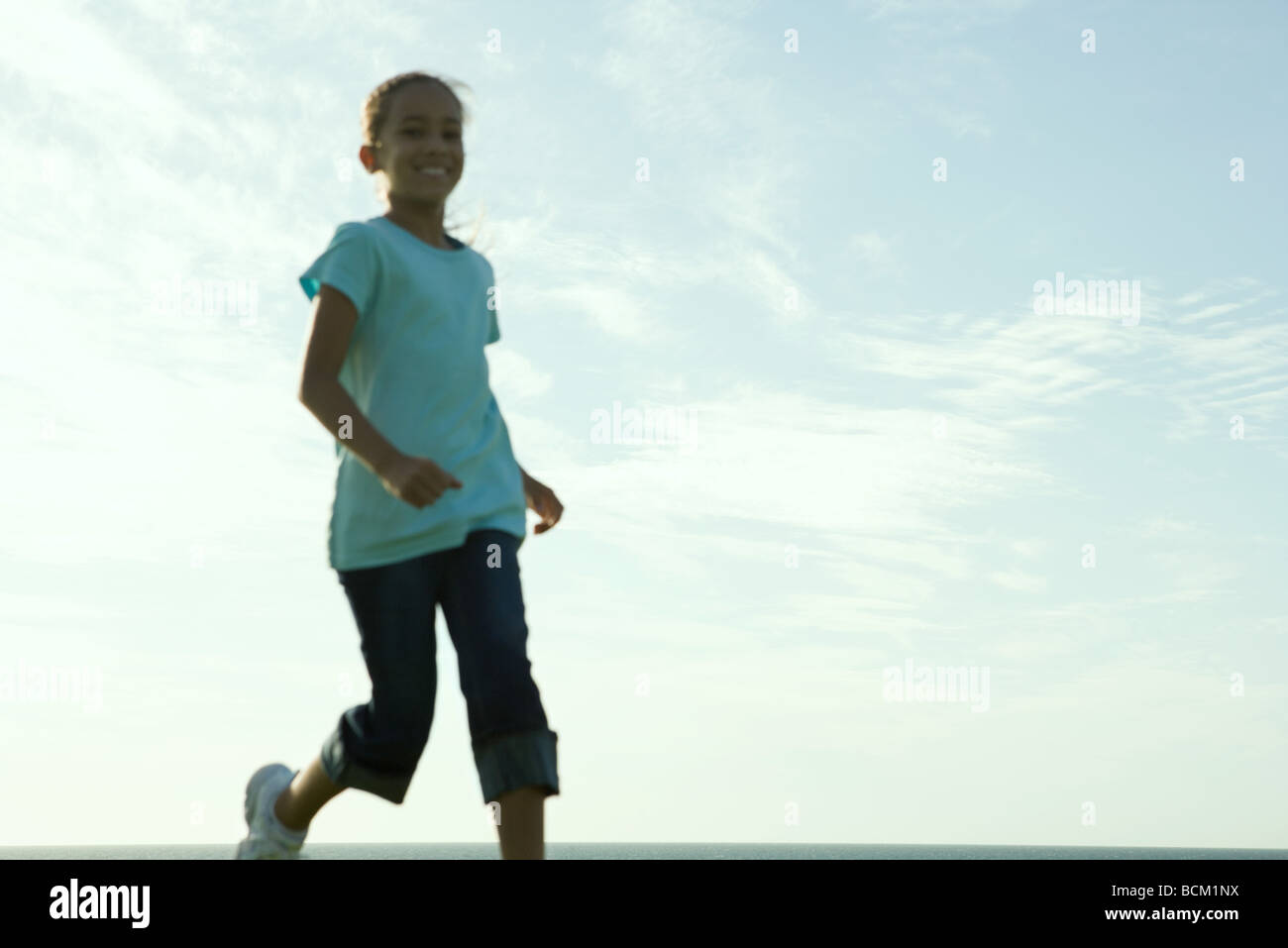 Girl running, low angle view, blurred Stock Photo - Alamy