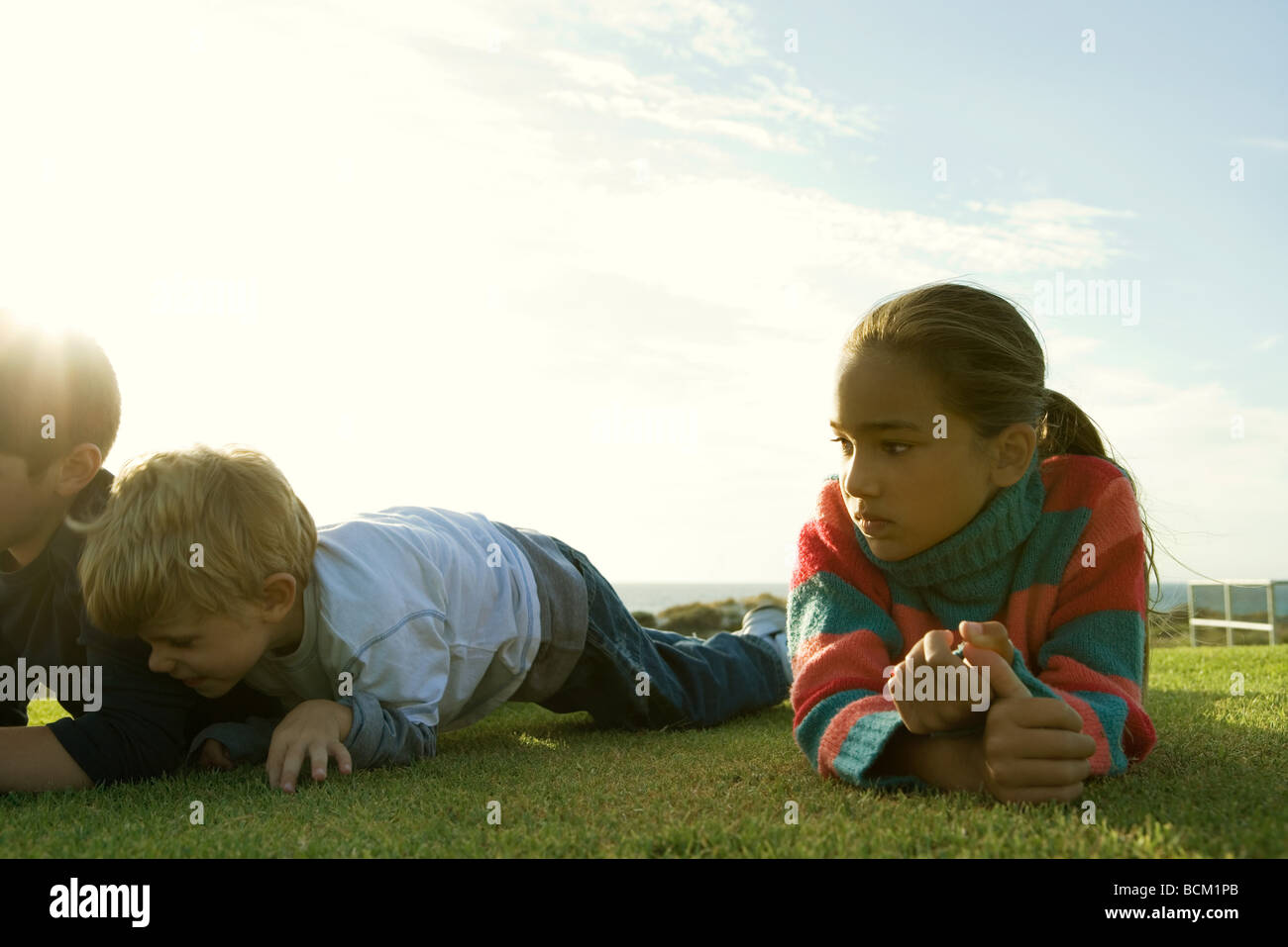 Kids wrestling on grass hi-res stock photography and images - Alamy