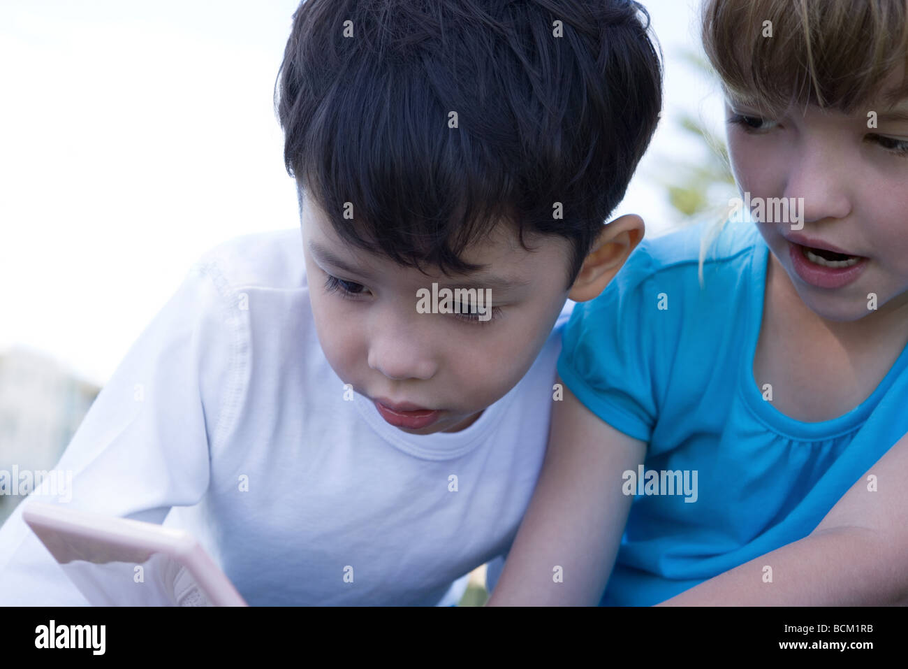 Children playing with handheld video game, close-up Stock Photo - Alamy