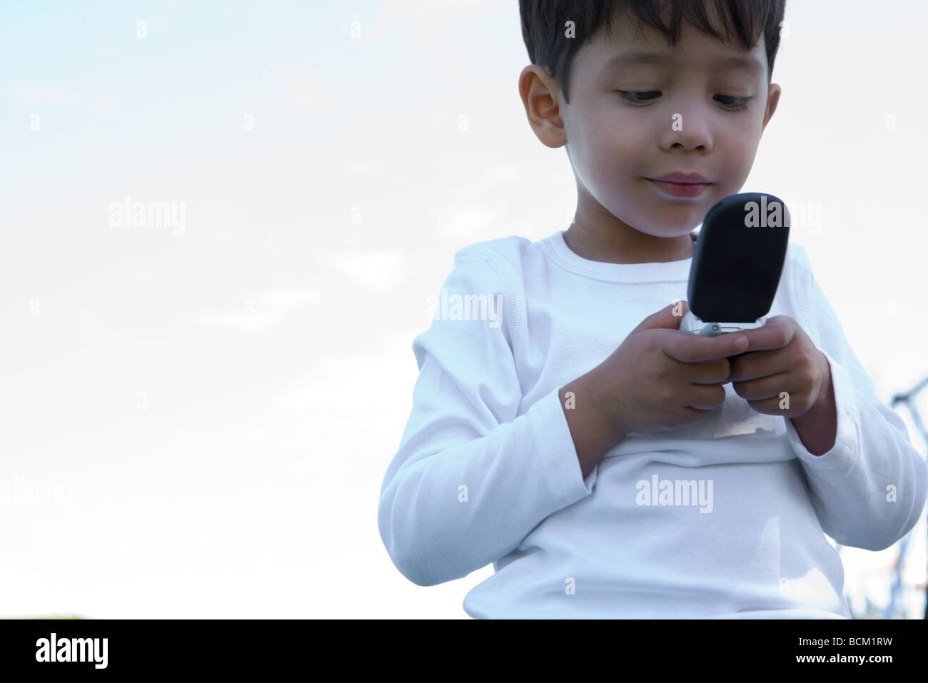 Boy using cell phone, low angle view Stock Photo - Alamy