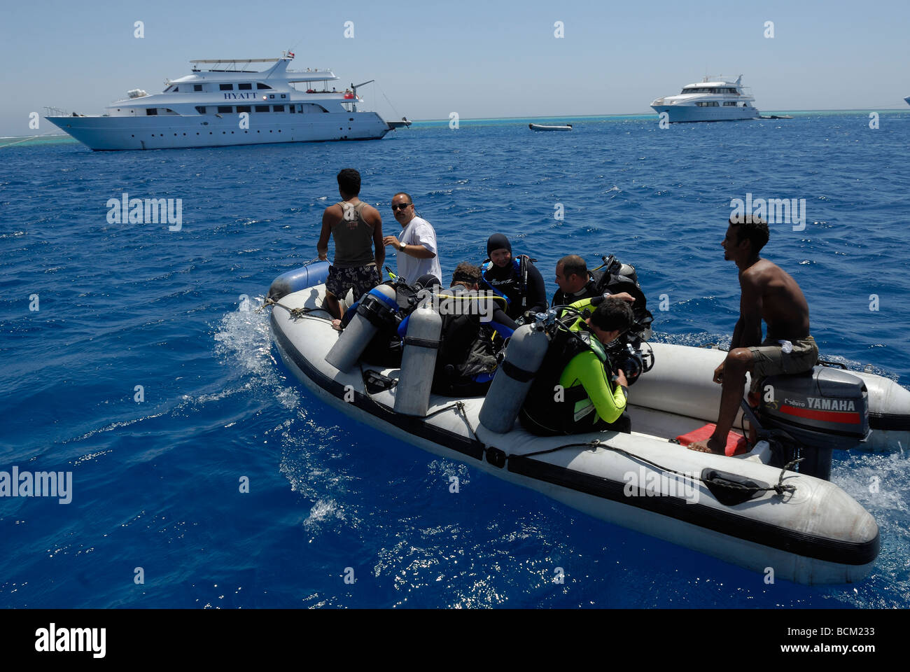 Group of scuba divers going to dive with an inflatable boat Stock Photo ...