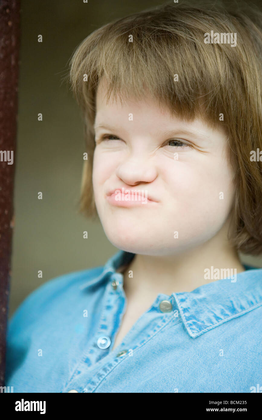 Girl with Down's Syndrome frowning, looking away, portrait Stock Photo ...