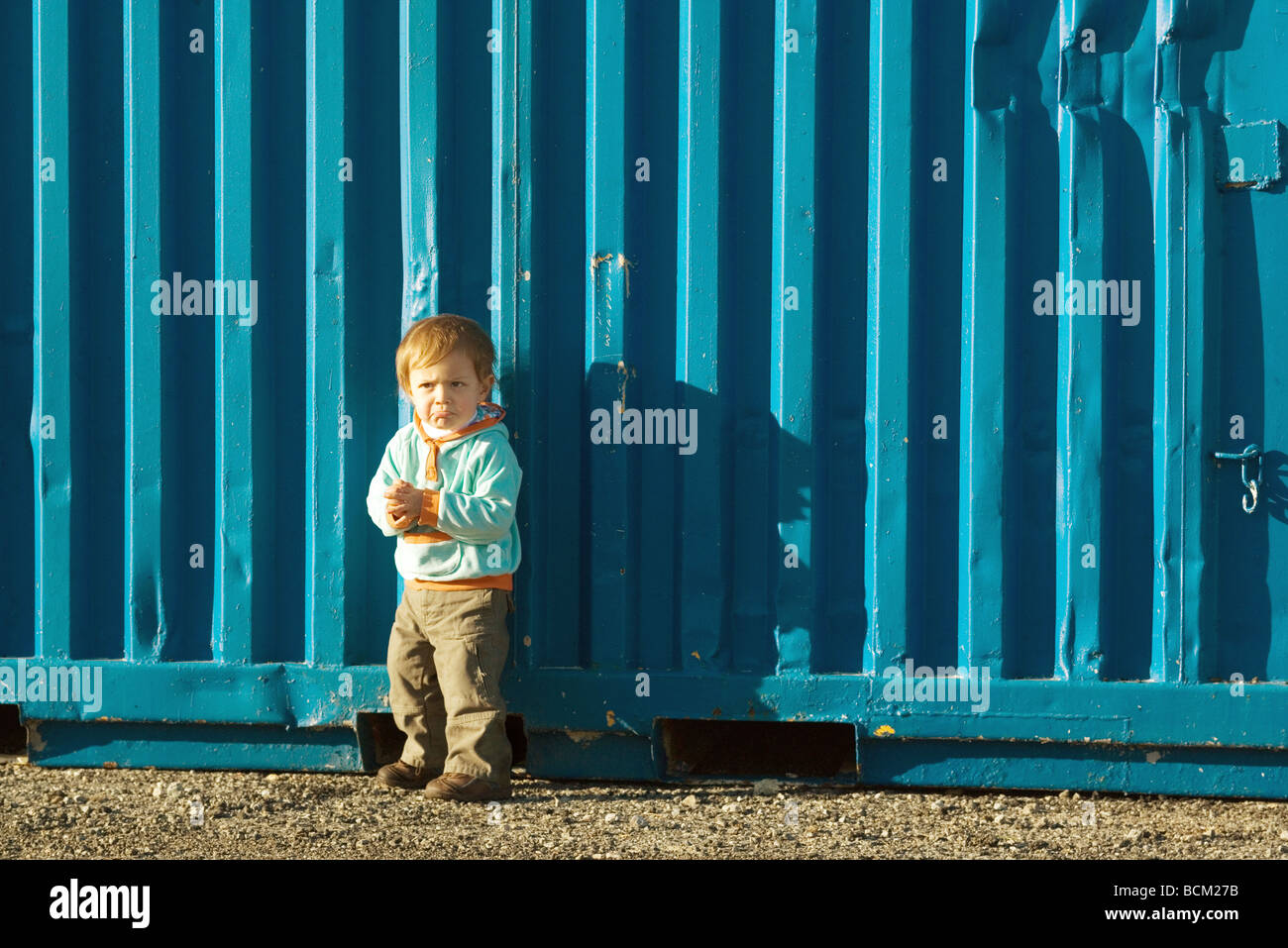 Little boy standing outdoors, frowning, looking away Stock Photo - Alamy