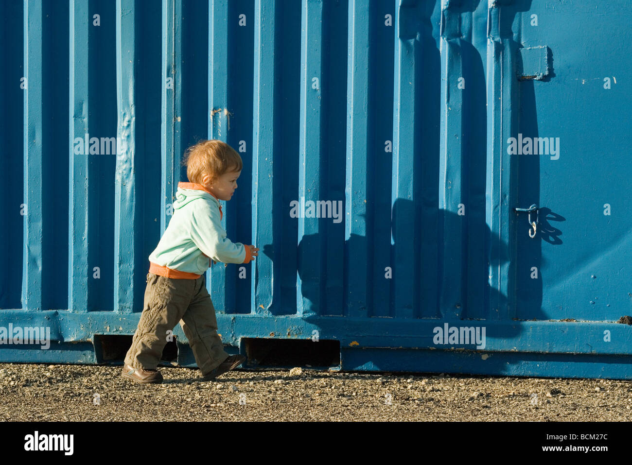 Little boy walking outdoors, side view Stock Photo - Alamy