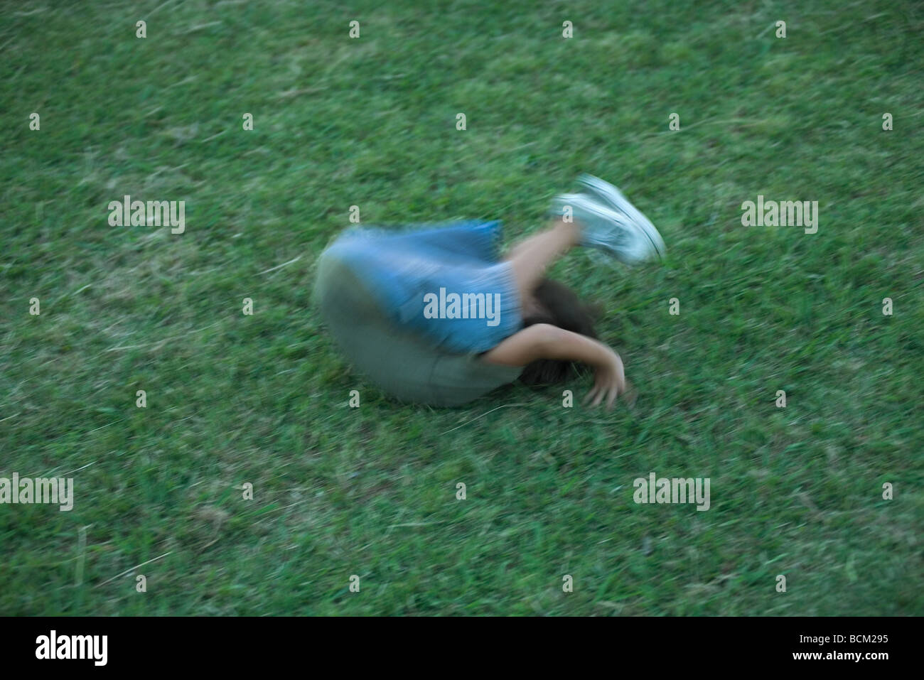 Little boy doing a somersault outdoors, blurred motion Stock Photo - Alamy