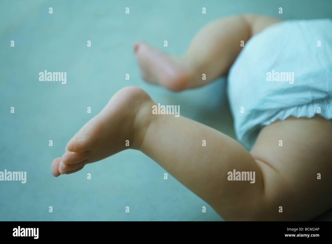 Baby crawling on the ground, cropped view Stock Photo - Alamy