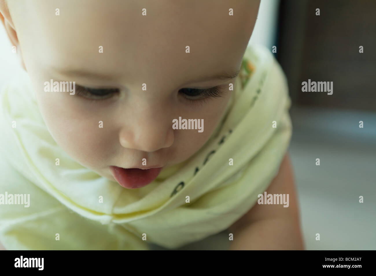 Baby looking down, close-up Stock Photo - Alamy
