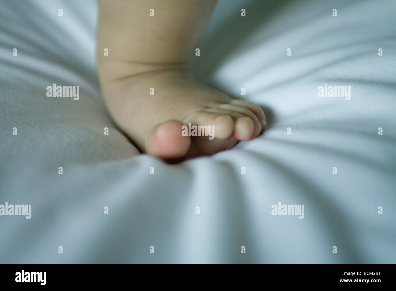 Baby standing, cropped view of one foot, close-up Stock Photo - Alamy