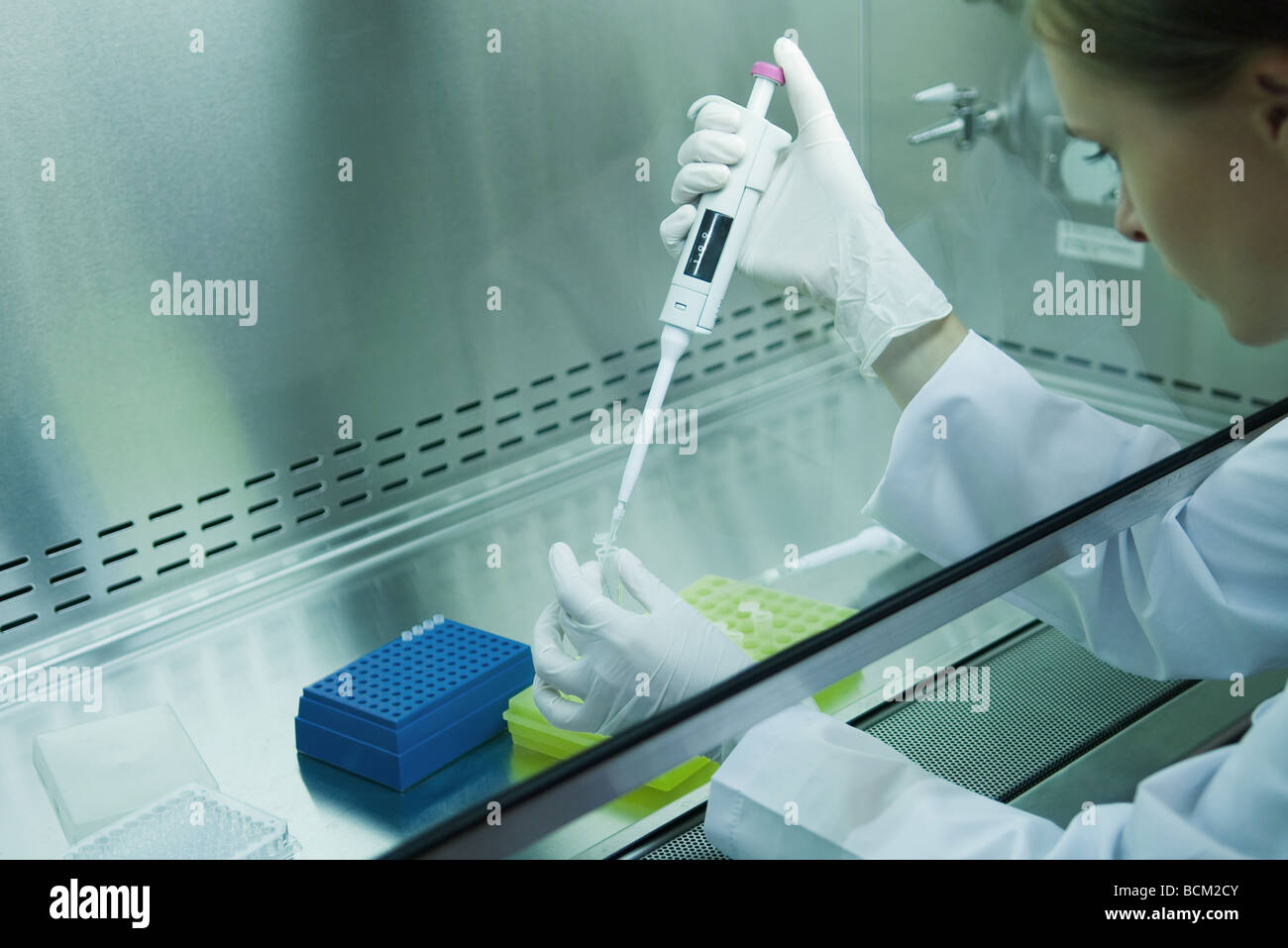 Female scientist filling test tube in laboratory, side view Stock Photo ...
