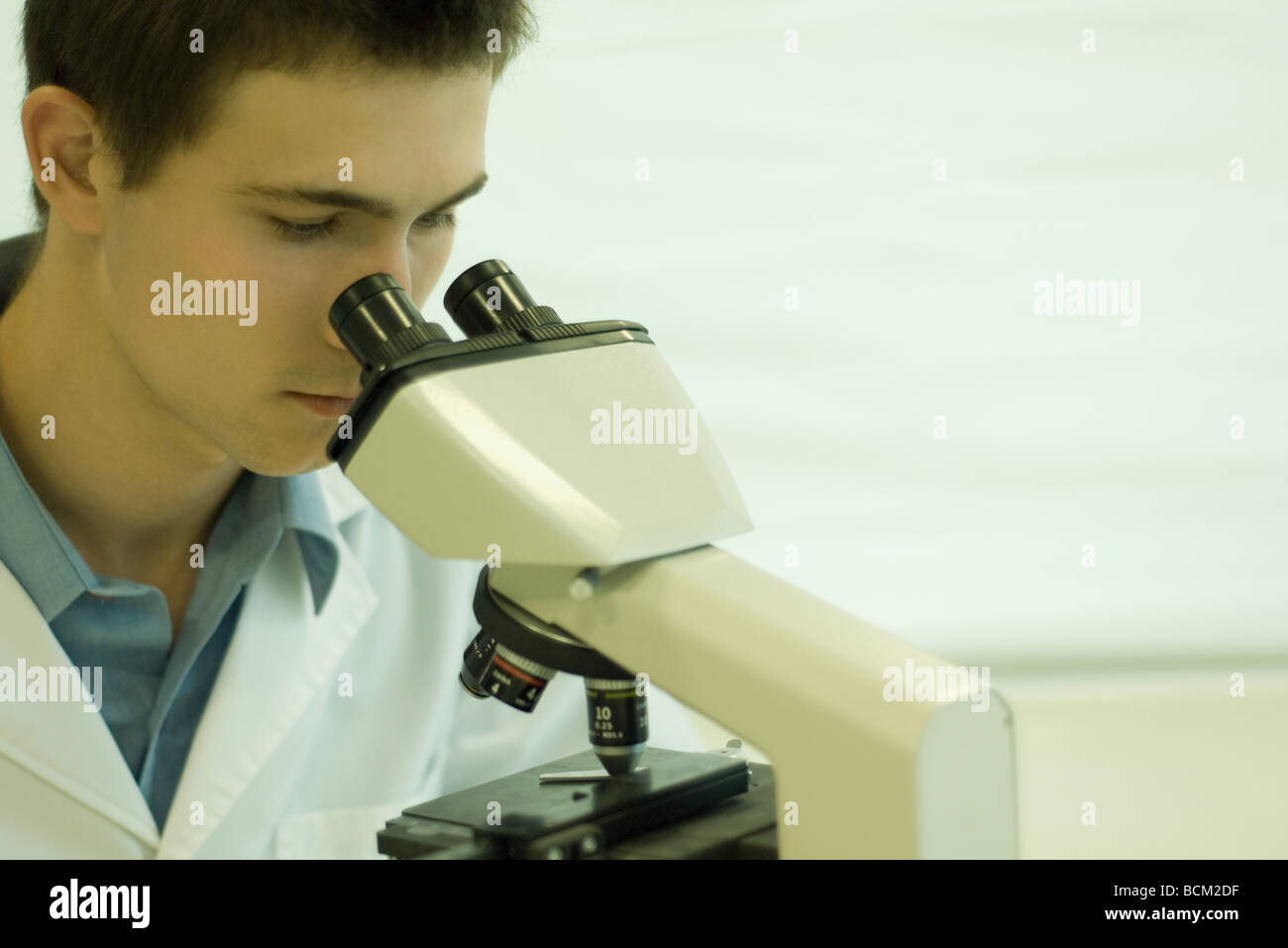 Male scientist looking through microscope, close-up Stock Photo - Alamy