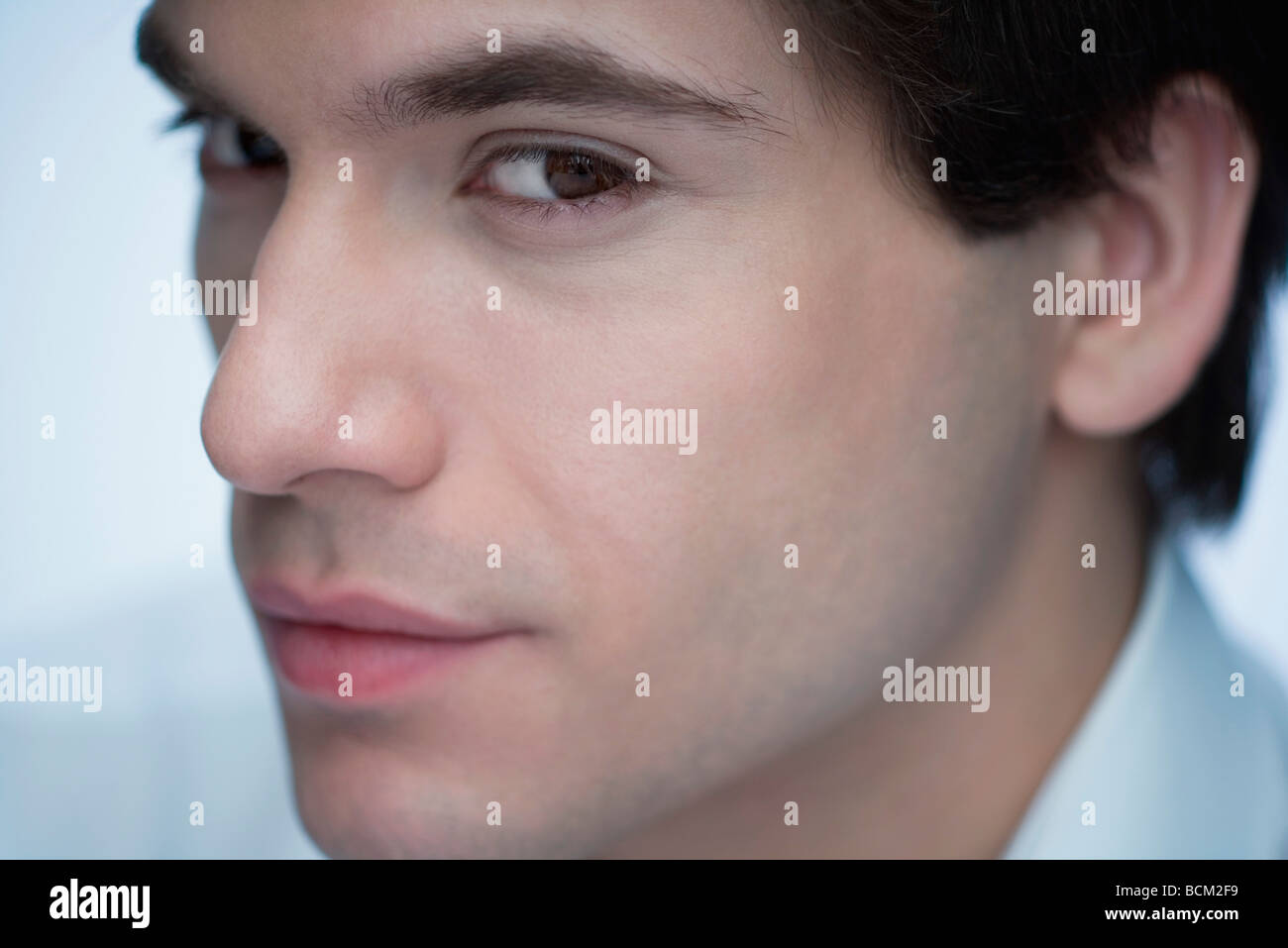 Young man glancing sideways at camera, close-up Stock Photo - Alamy