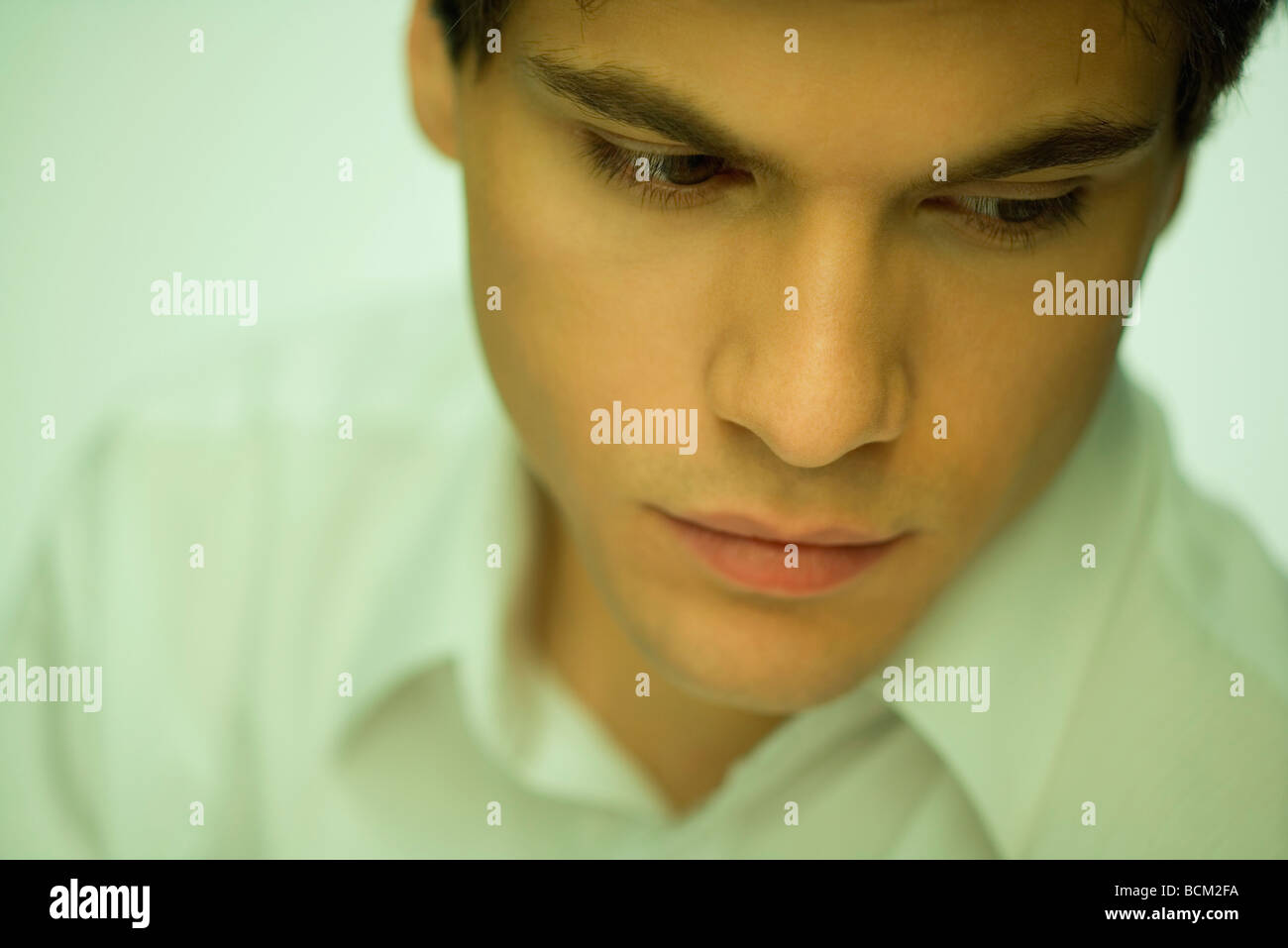 Young man looking down, portrait Stock Photo - Alamy
