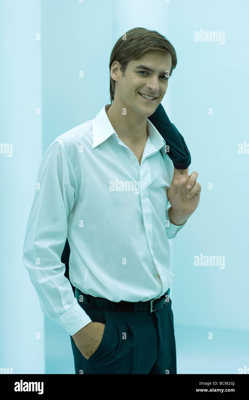 Man holding jacket over shoulder, smiling, portrait Stock Photo - Alamy