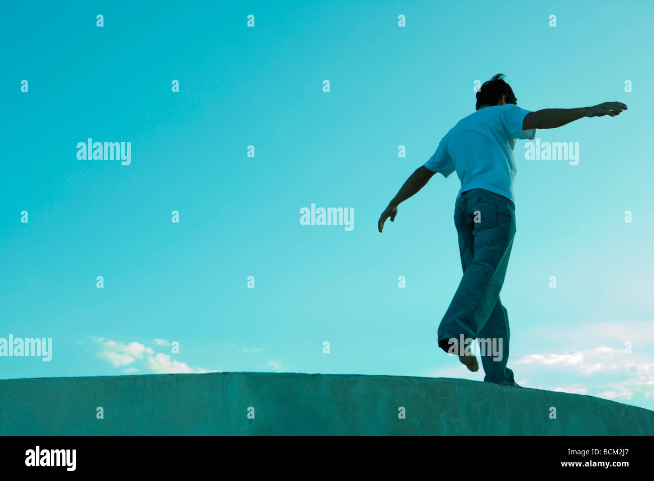 Young man standing one leg hi-res stock photography and images - Alamy