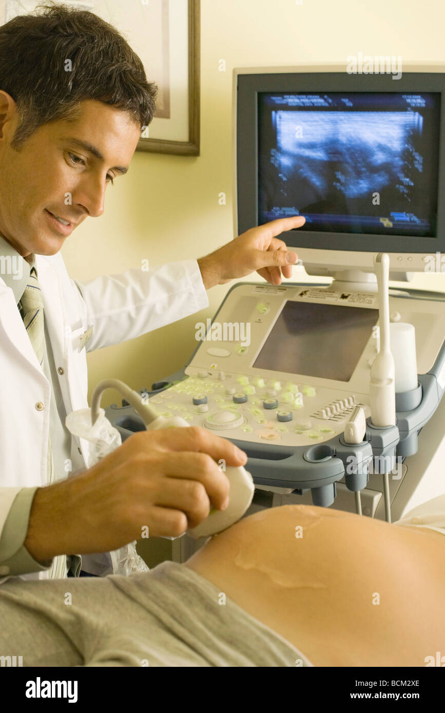 Doctor performing ultrasound on pregnant woman, cropped Stock Photo - Alamy