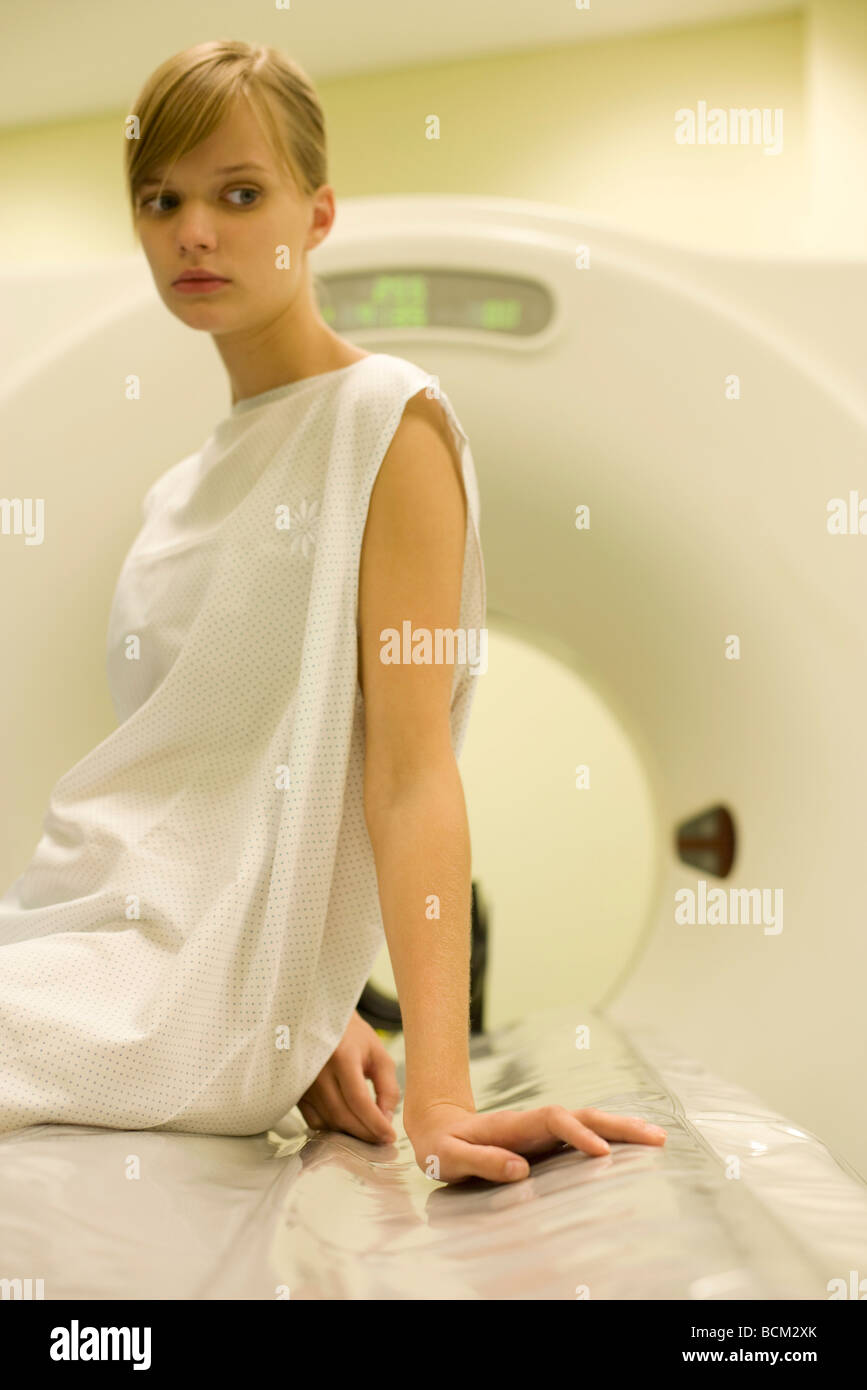 Female patient sitting on MRI scanner, glancing sideways Stock Photo ...