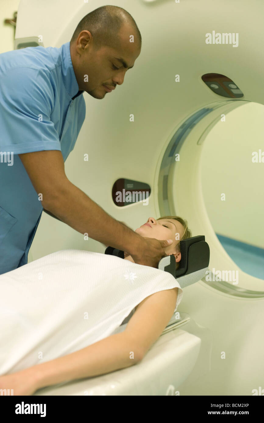 Radiologist preparing female patient for MRI Stock Photo - Alamy