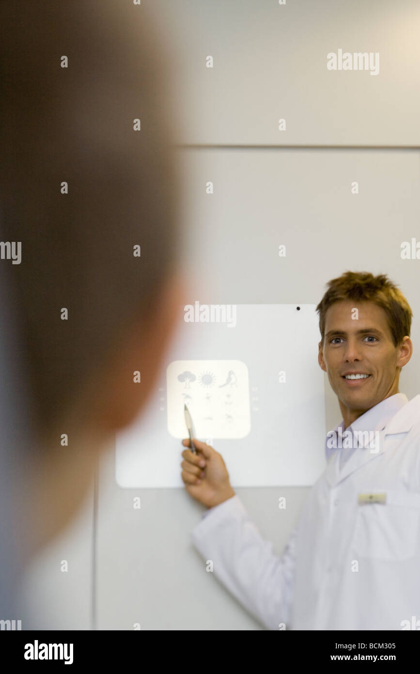 Doctor giving patient vision test, focus on background Stock Photo - Alamy