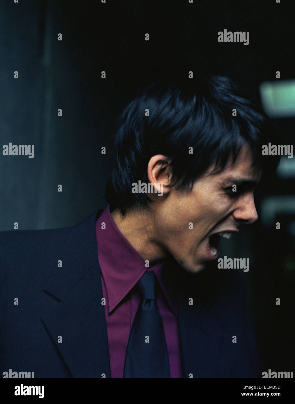 Man in suit yelling, side view Stock Photo - Alamy