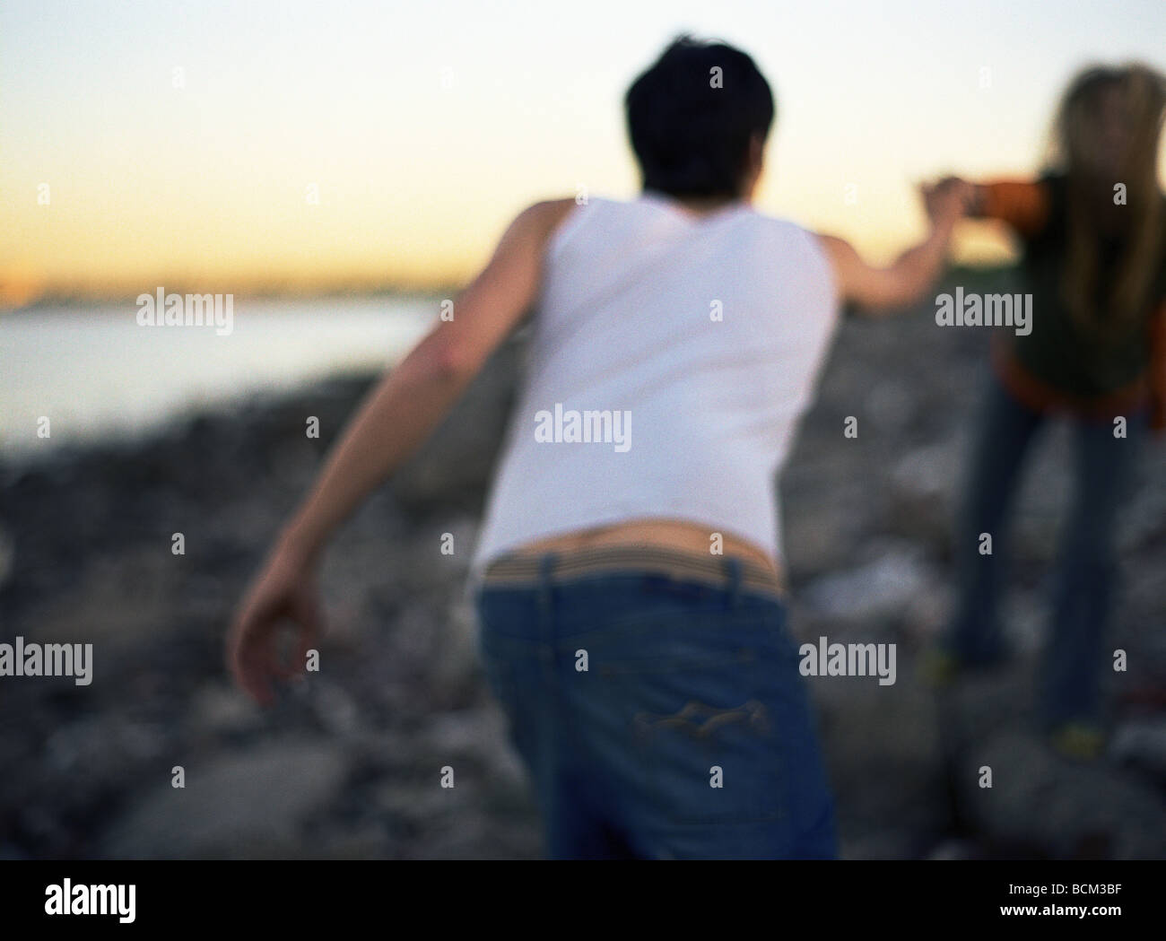 Young man reaching for woman's hand, rear view Stock Photo - Alamy