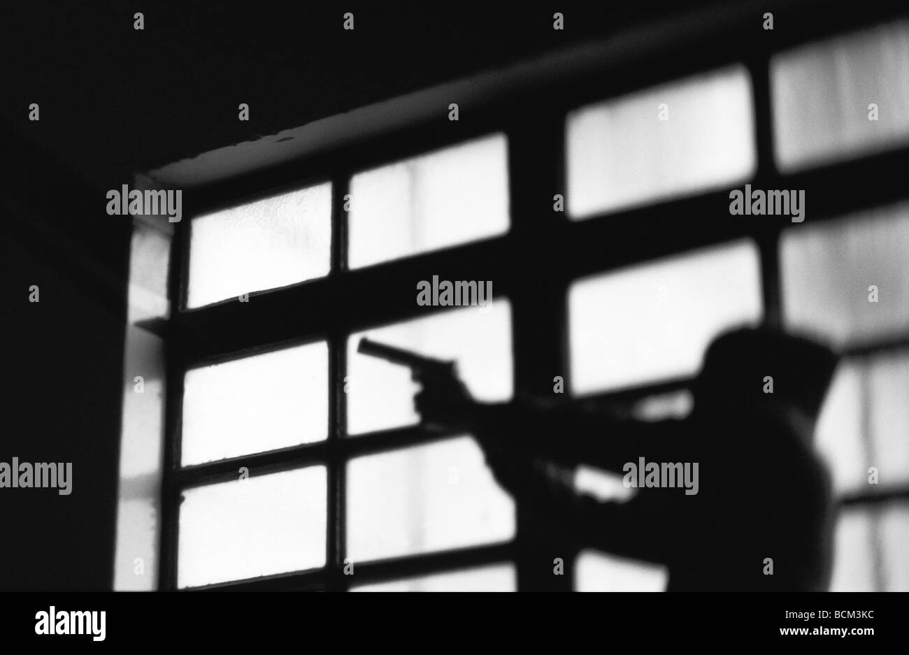 Dark silhouette of person pointing gun Stock Photo - Alamy