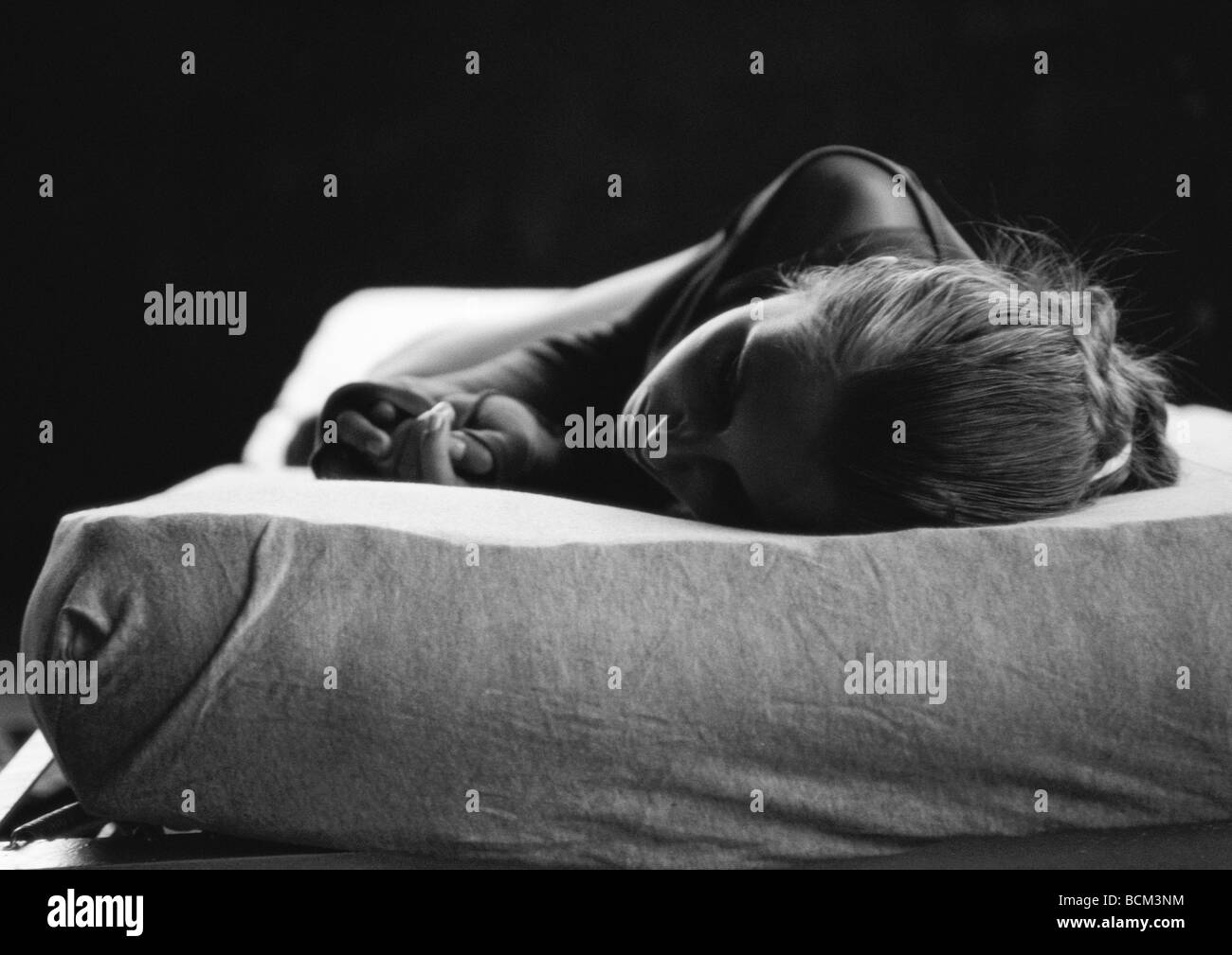 Woman lying on mattress Stock Photo - Alamy