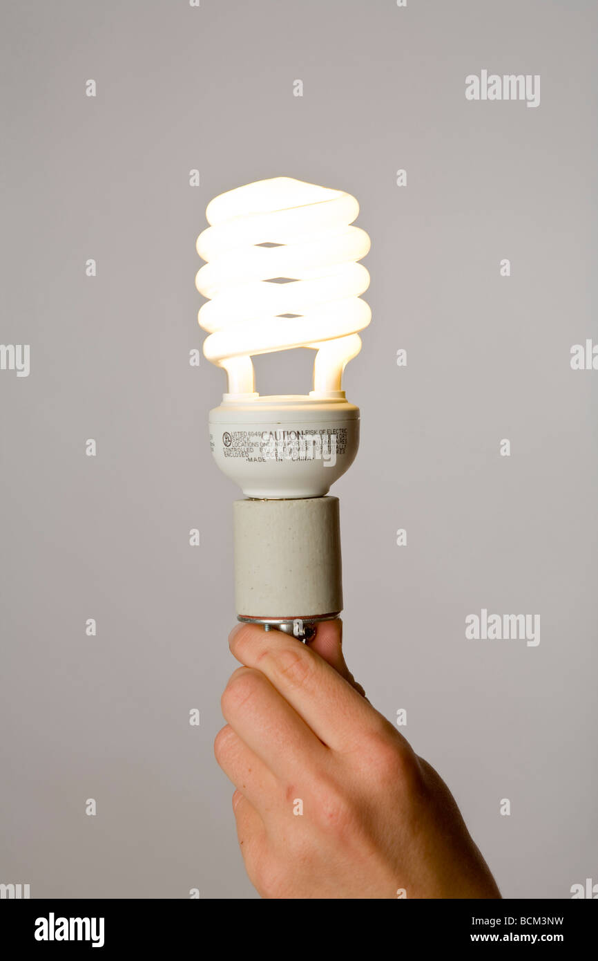 Hand holding a new Energy efficient Compact fluorescent lightbulb Stock ...
