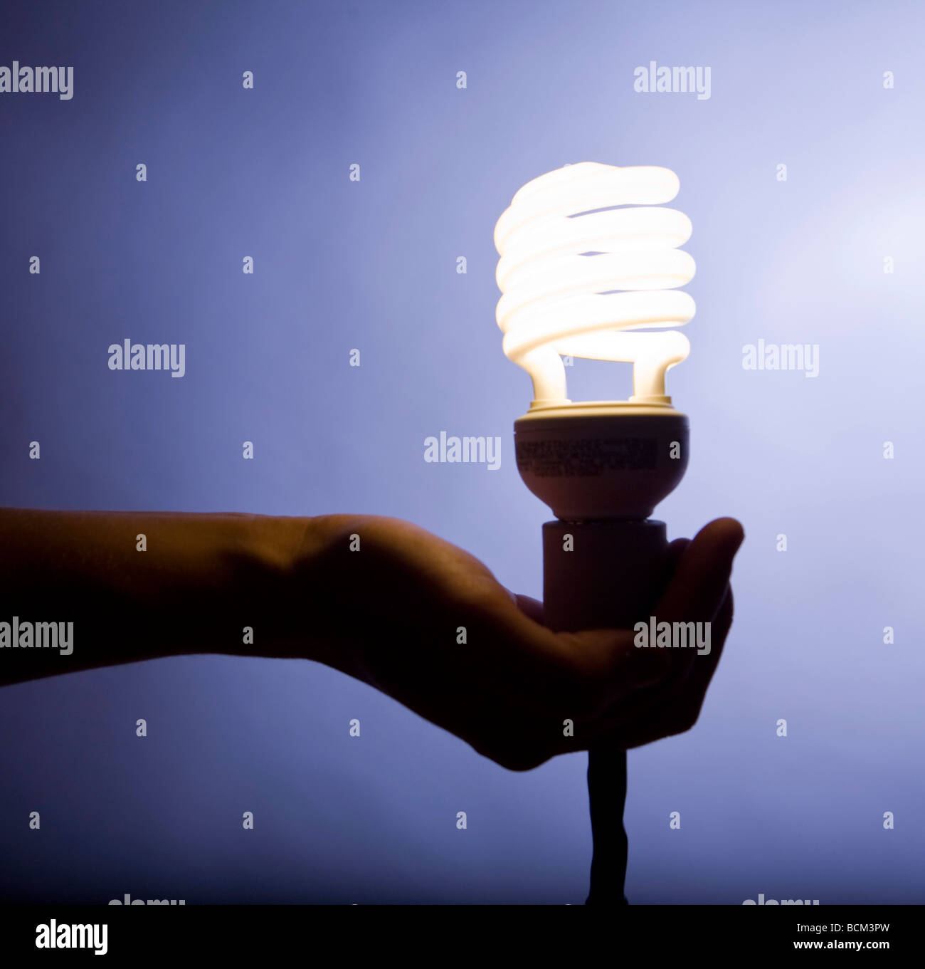 Hand holding lit up lightbulb hi-res stock photography and images - Alamy