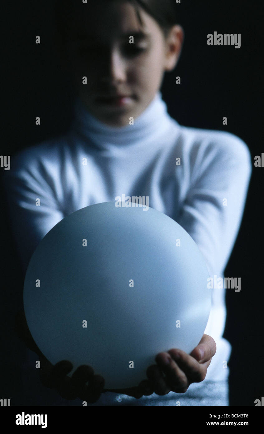 Child holding sphere in hands Stock Photo - Alamy