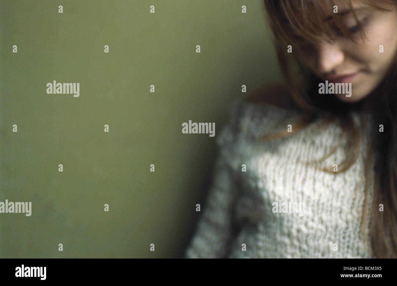 Young woman looking down, portrait Stock Photo - Alamy