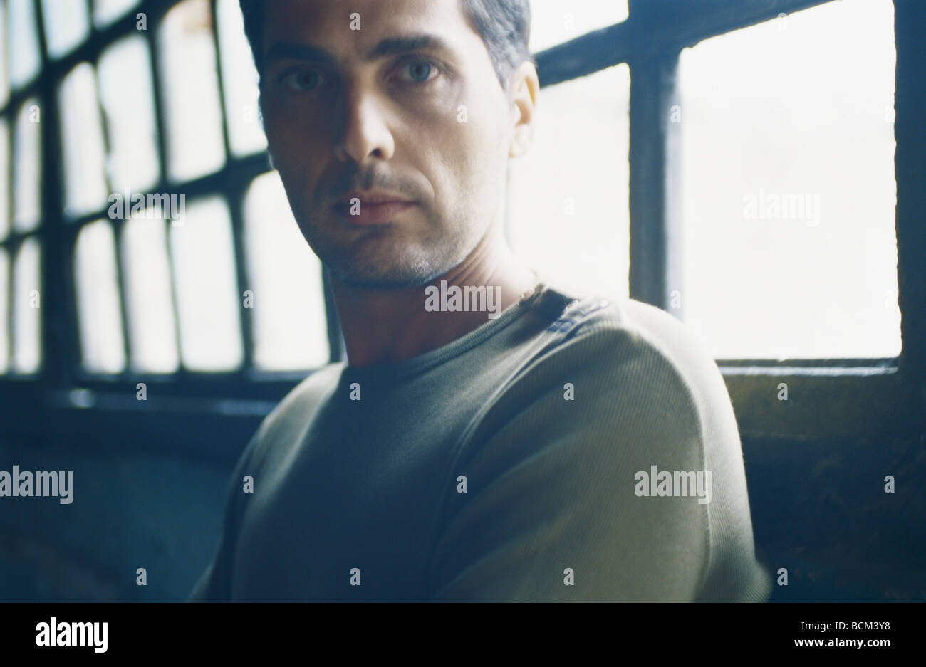 Man looking at camera, backlit Stock Photo - Alamy