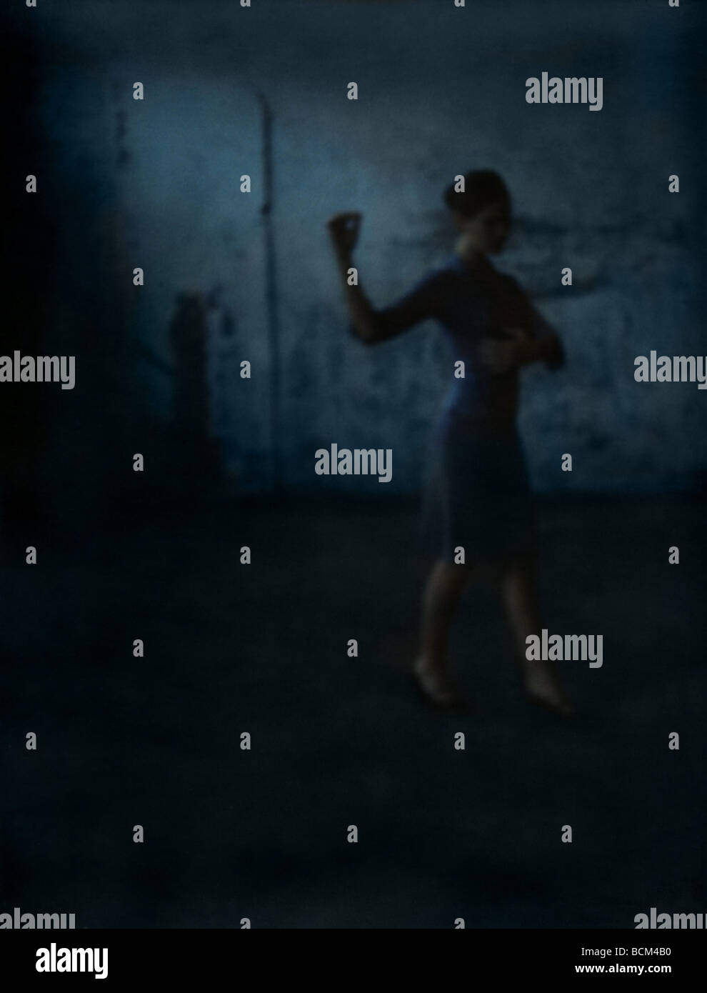 Young woman dancing in the dark Stock Photo - Alamy