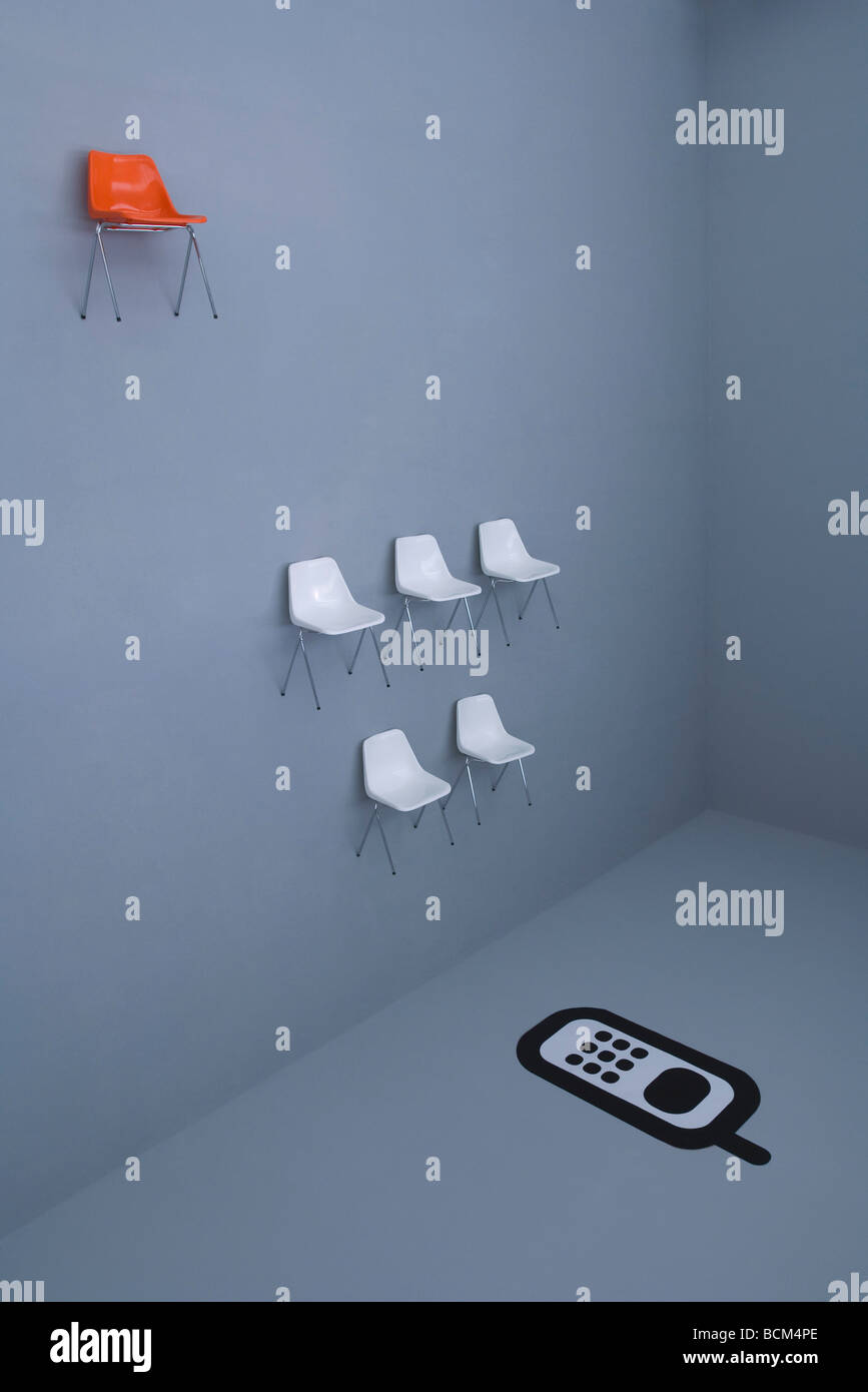 Chairs arranged in form of upside down pyramid in front of large cell ...