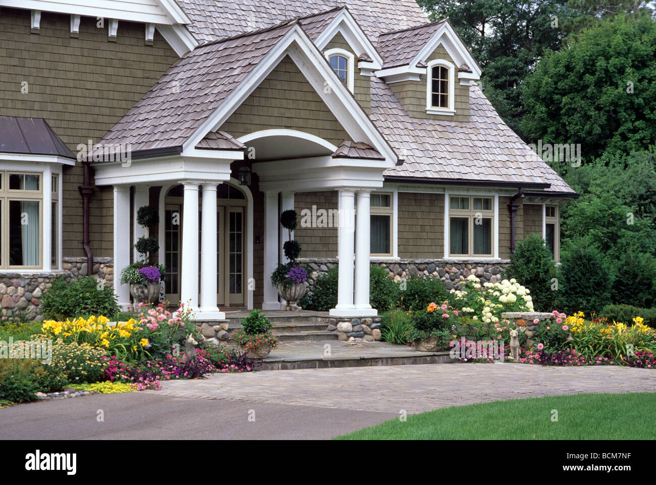 FRONT ENTRANCE TO UPSCALE MINNEAPOLIS, MINNESOTA HOME. TOPIARY TREES ...