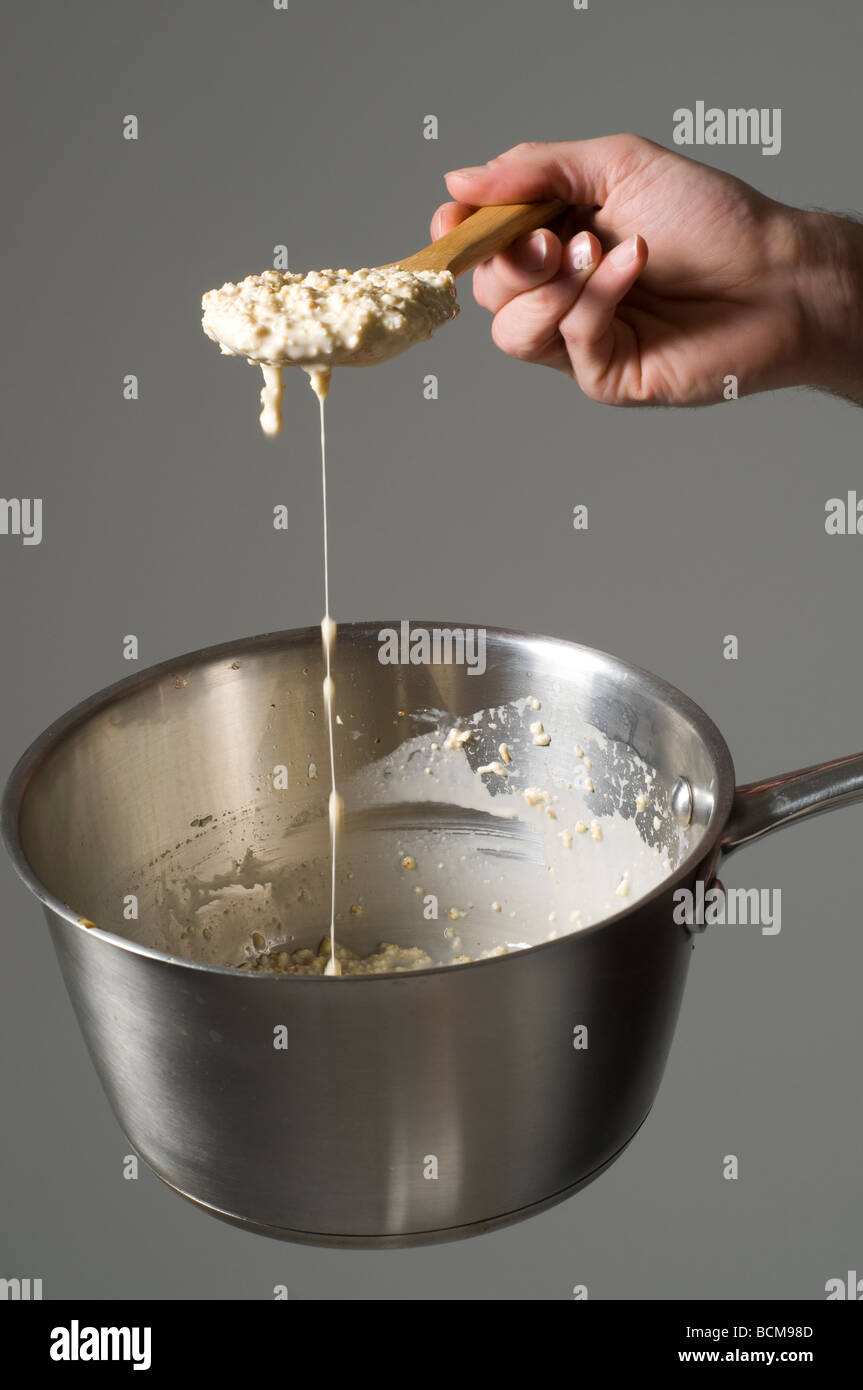 bland porridge dripping from spoon Stock Photo - Alamy