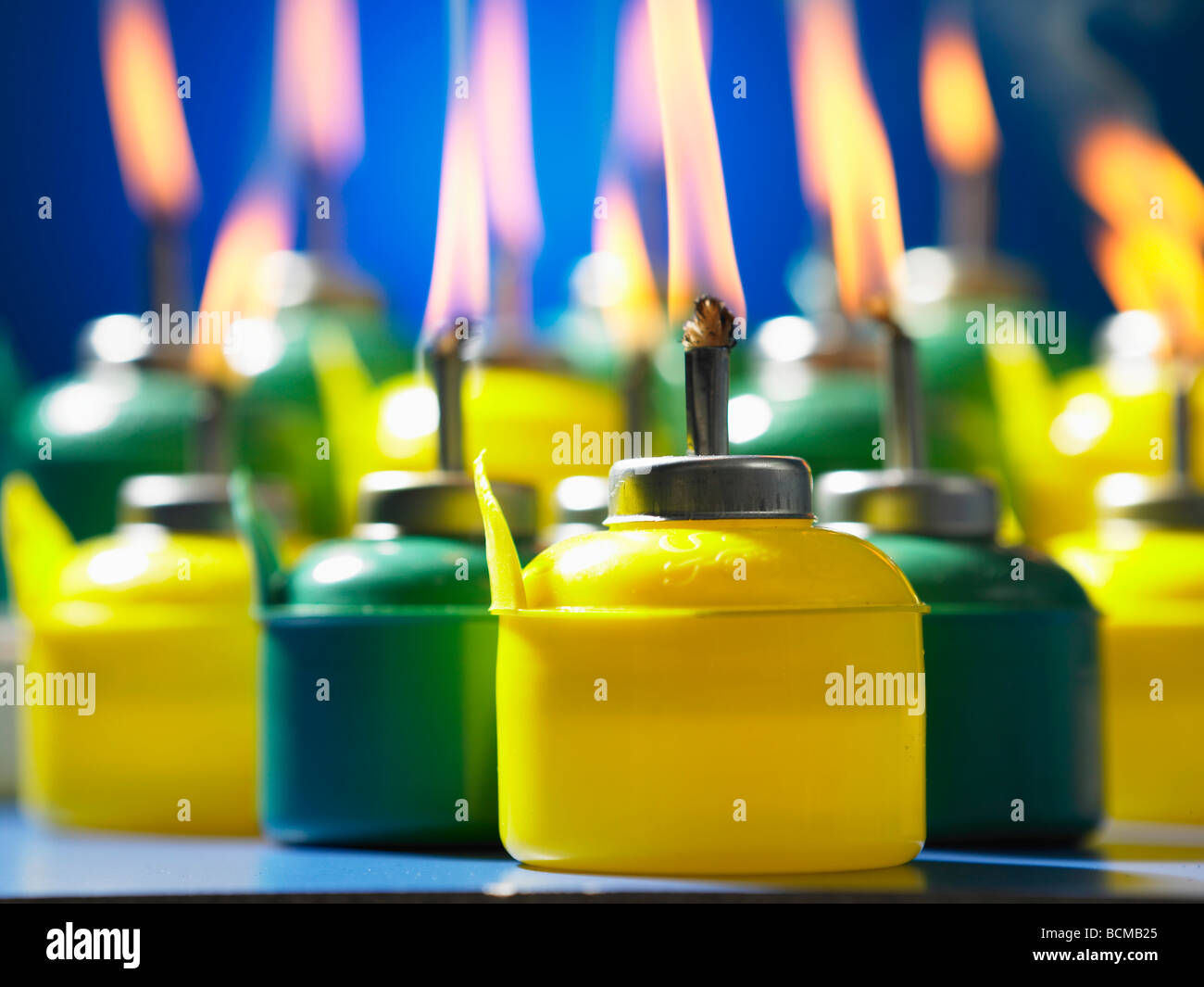 burning oil lamp on blue background Stock Photo - Alamy